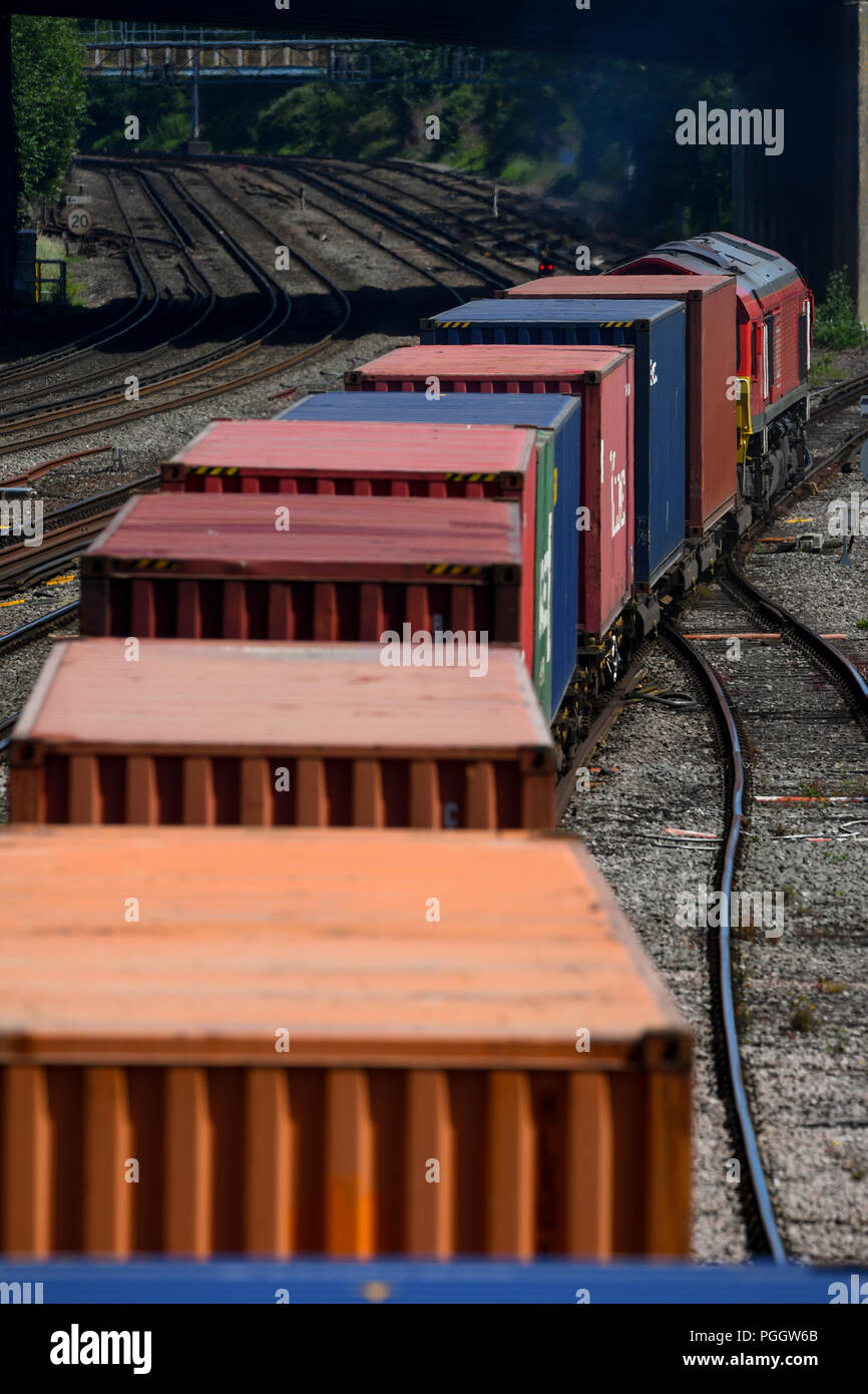 Container railway train travelling on the main line into Southampton ...