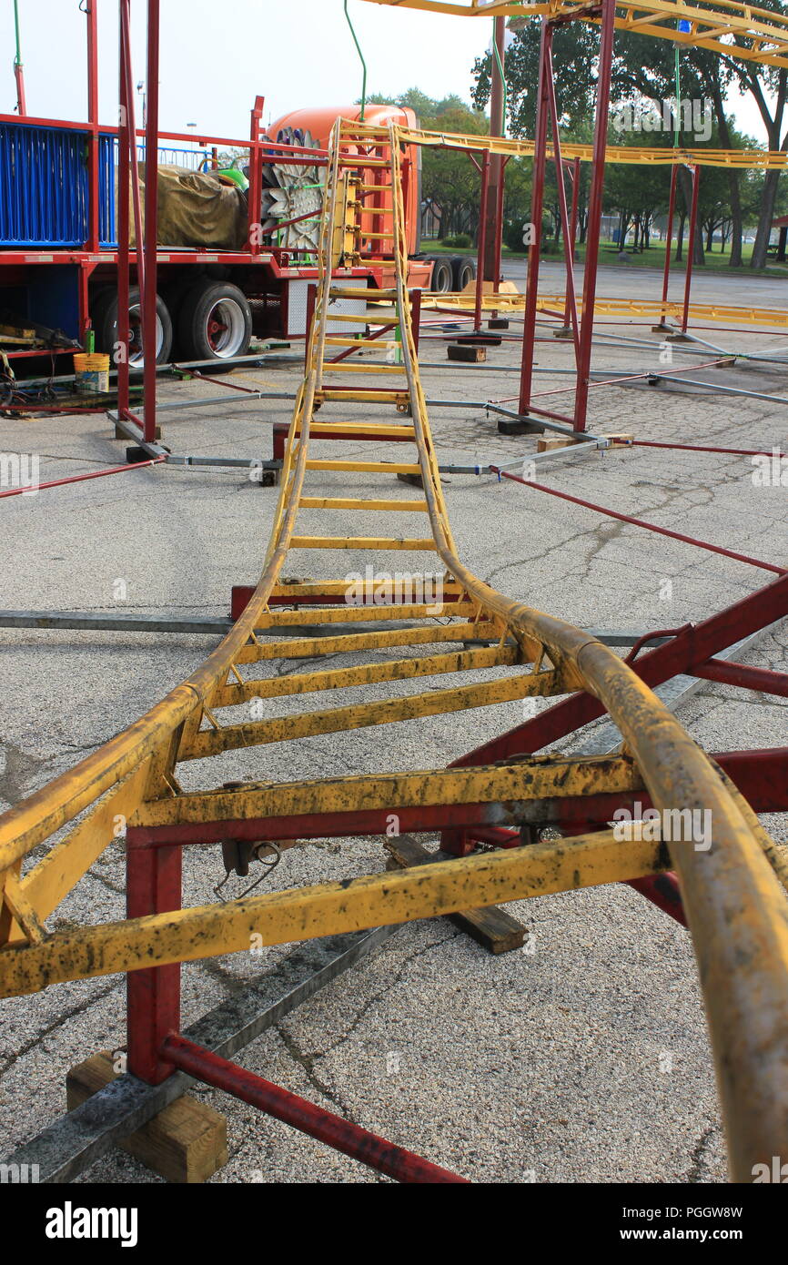 Traveling kiddie carnival ride roller coaster under construction in a ...