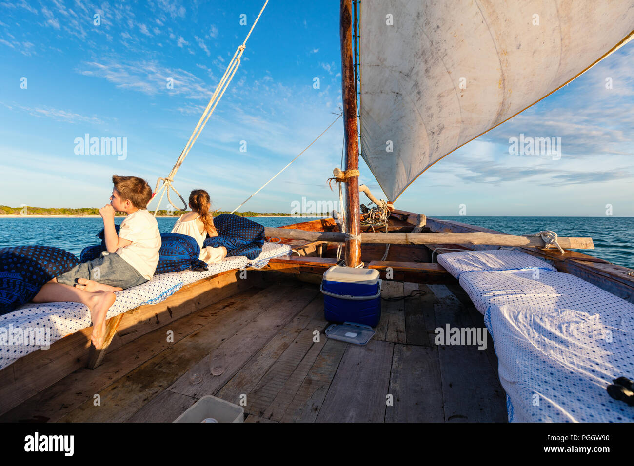 Kids sailing on a traditional African dhow boat at sunset Stock Photo ...
