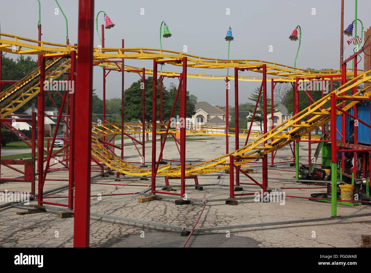 Traveling kiddie carnival ride roller coaster under construction in a ...