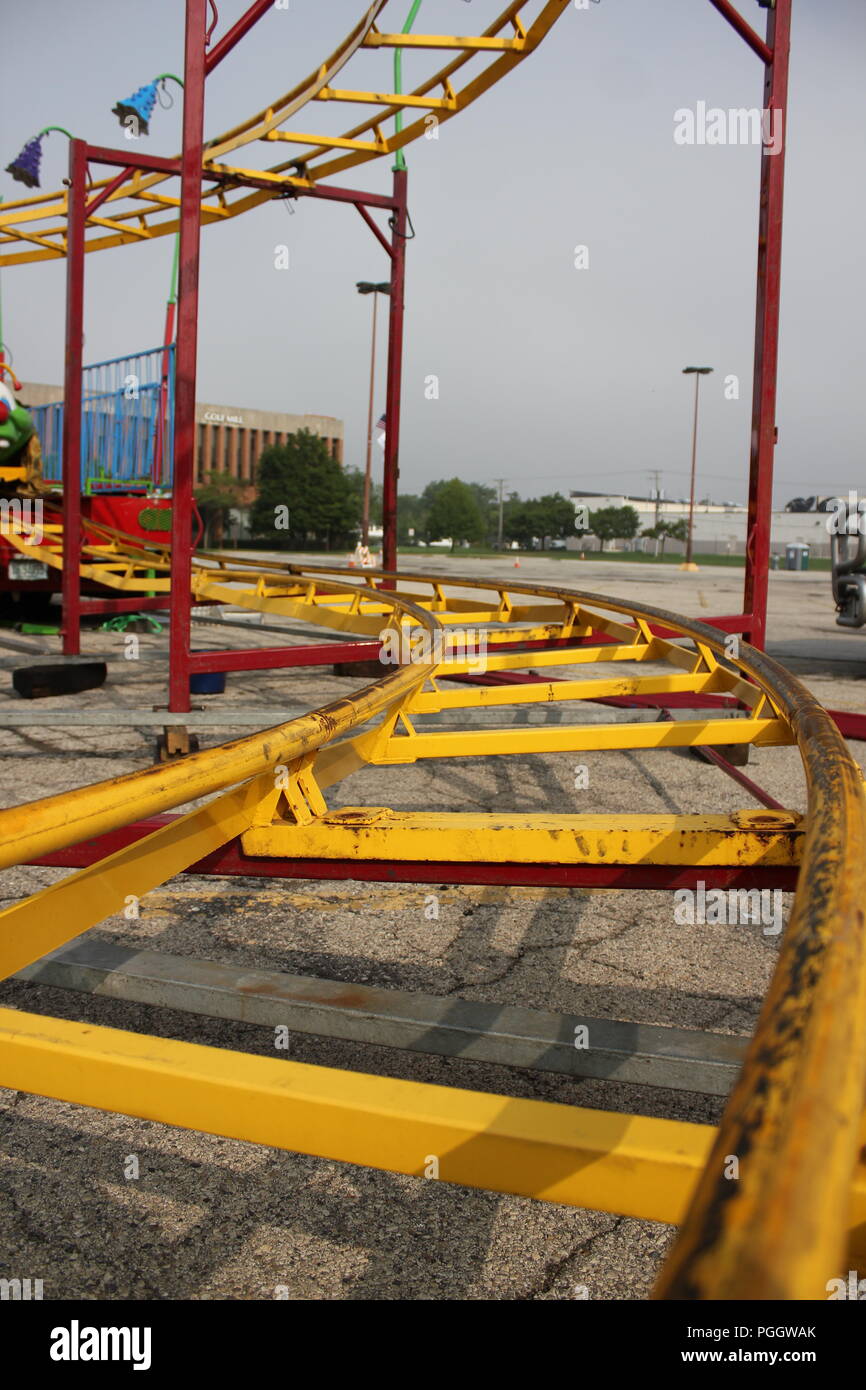 Traveling kiddie carnival ride roller coaster under construction in a ...