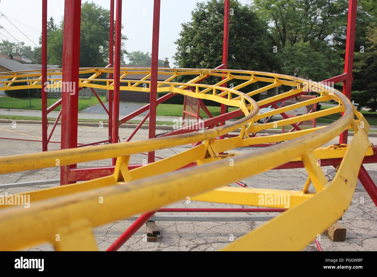 Traveling kiddie carnival ride roller coaster rail tracks under ...