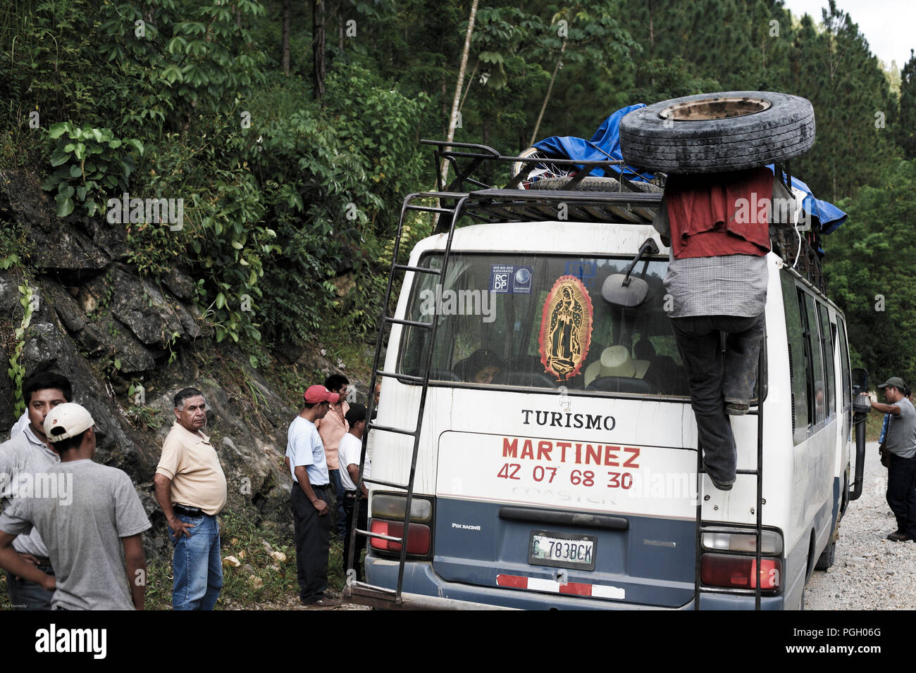 Small bus with flat tire on unsealed road Stock Photo - Alamy