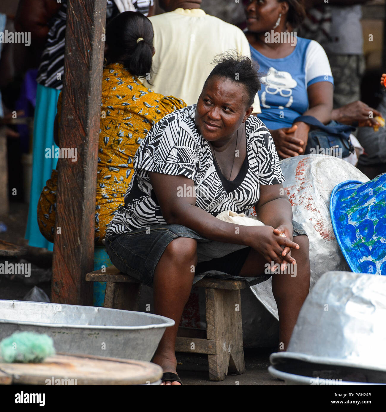 ELMINA, GHANA -JAN 18, 2017: Unidentified Ghanaian woman sits on wooden ...
