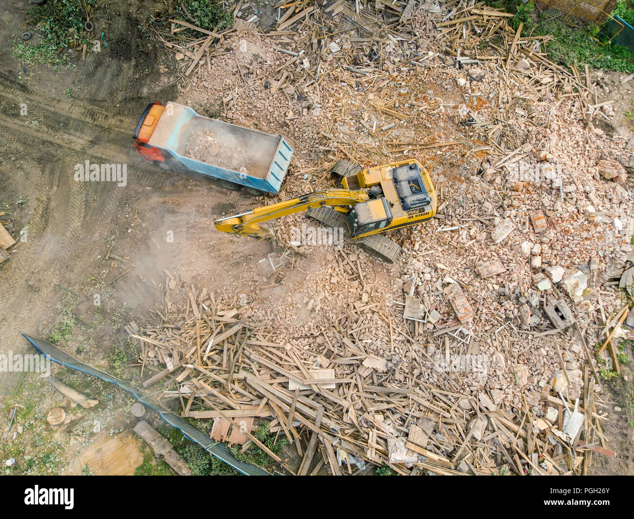 aerial photo of urban demolition site. excavator working in ruins and ...