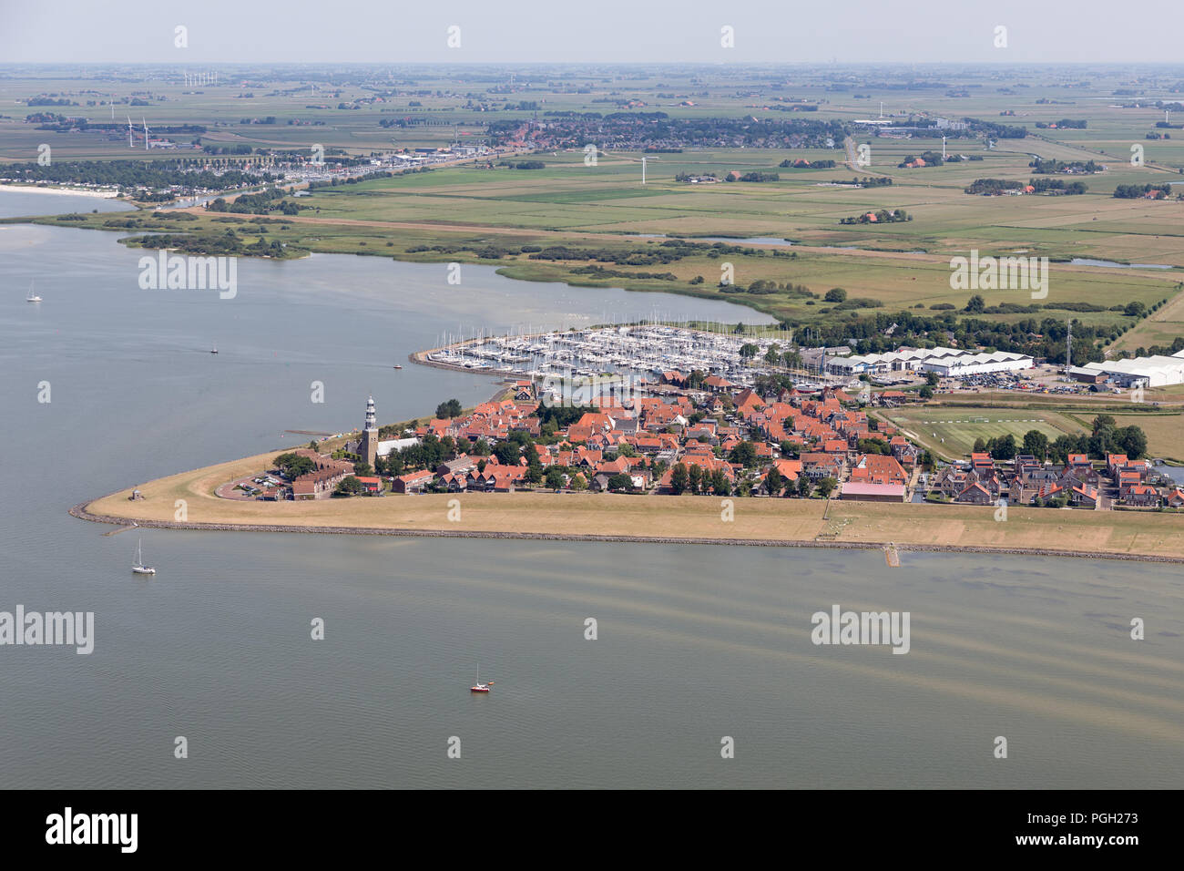 Aerial view Dutch village Hindeloopen at lake IJsselmeer with marina ...