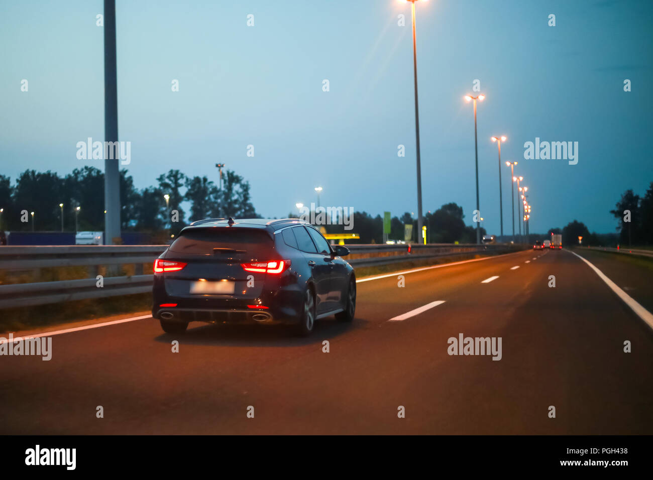 Car driving on the highway at sunset Stock Photo - Alamy