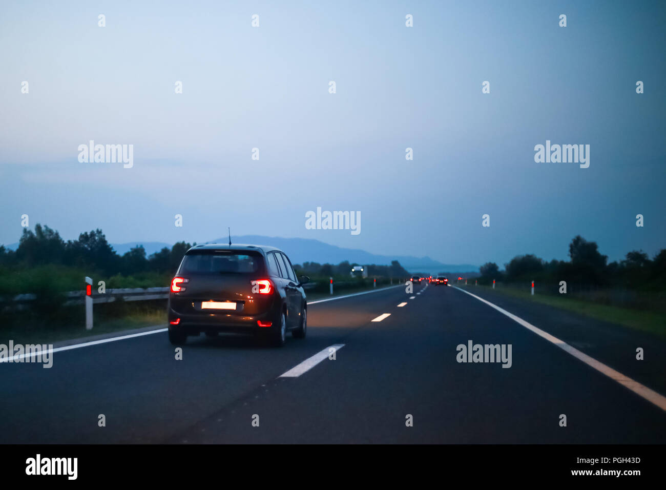 Car driving on the highway at sunset Stock Photo - Alamy