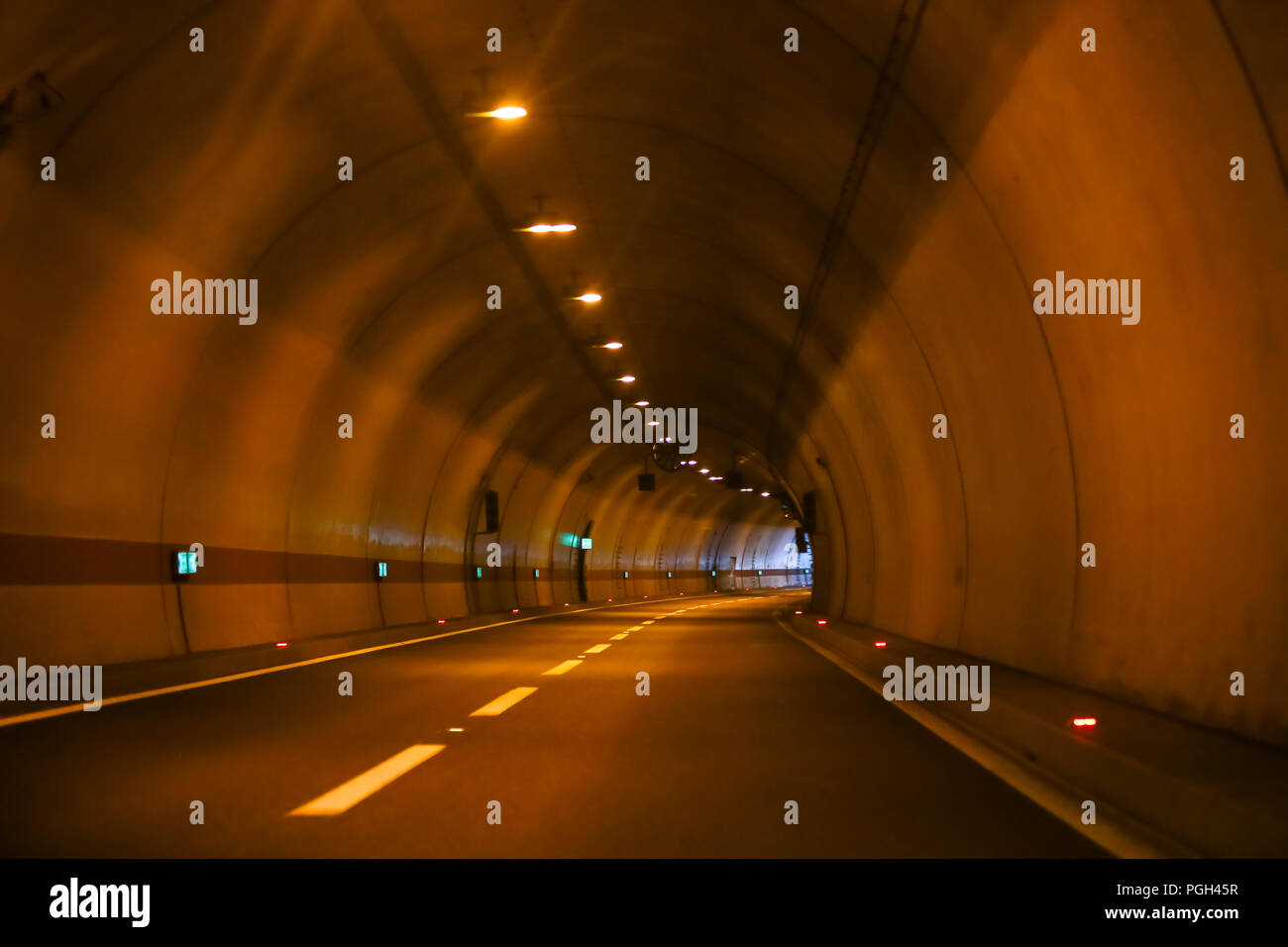 Curved empty highway tunnel with exit on the end Stock Photo - Alamy