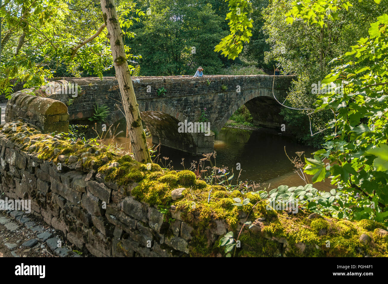Stone road bridge crossing the river Irwell at Edenfield Stock Photo ...
