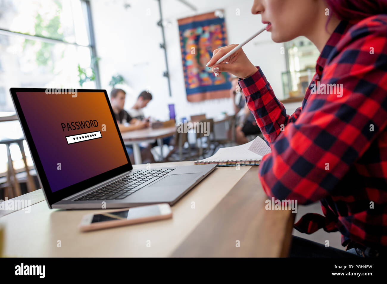 Side view of a young woman sitting in cafe, hand typing laptop computer ...