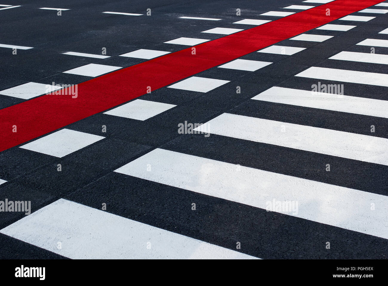 Diagonal shot of pedestrian crossing, with black and white stripes and ...