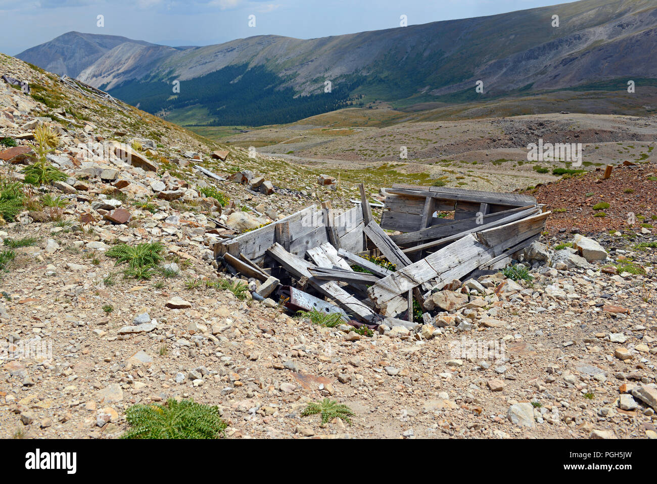 Remains of old mine and vintage mining log cabin in the mountains in ...