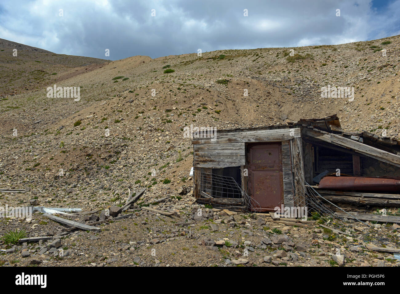 Remains of old mine and vintage mining log cabin in the mountains in ...