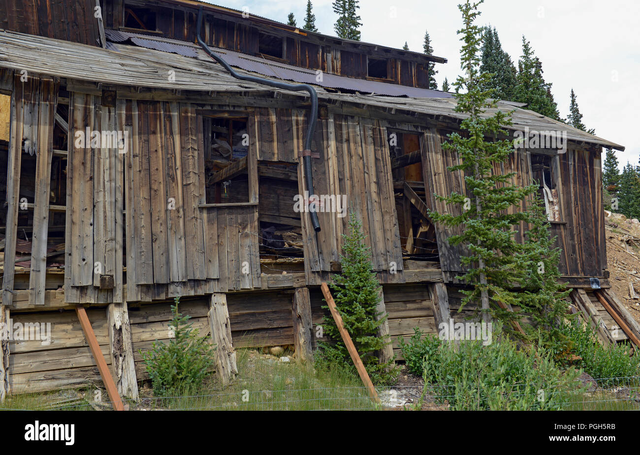 Remains of old mine and vintage mining log cabin in the mountains in ...