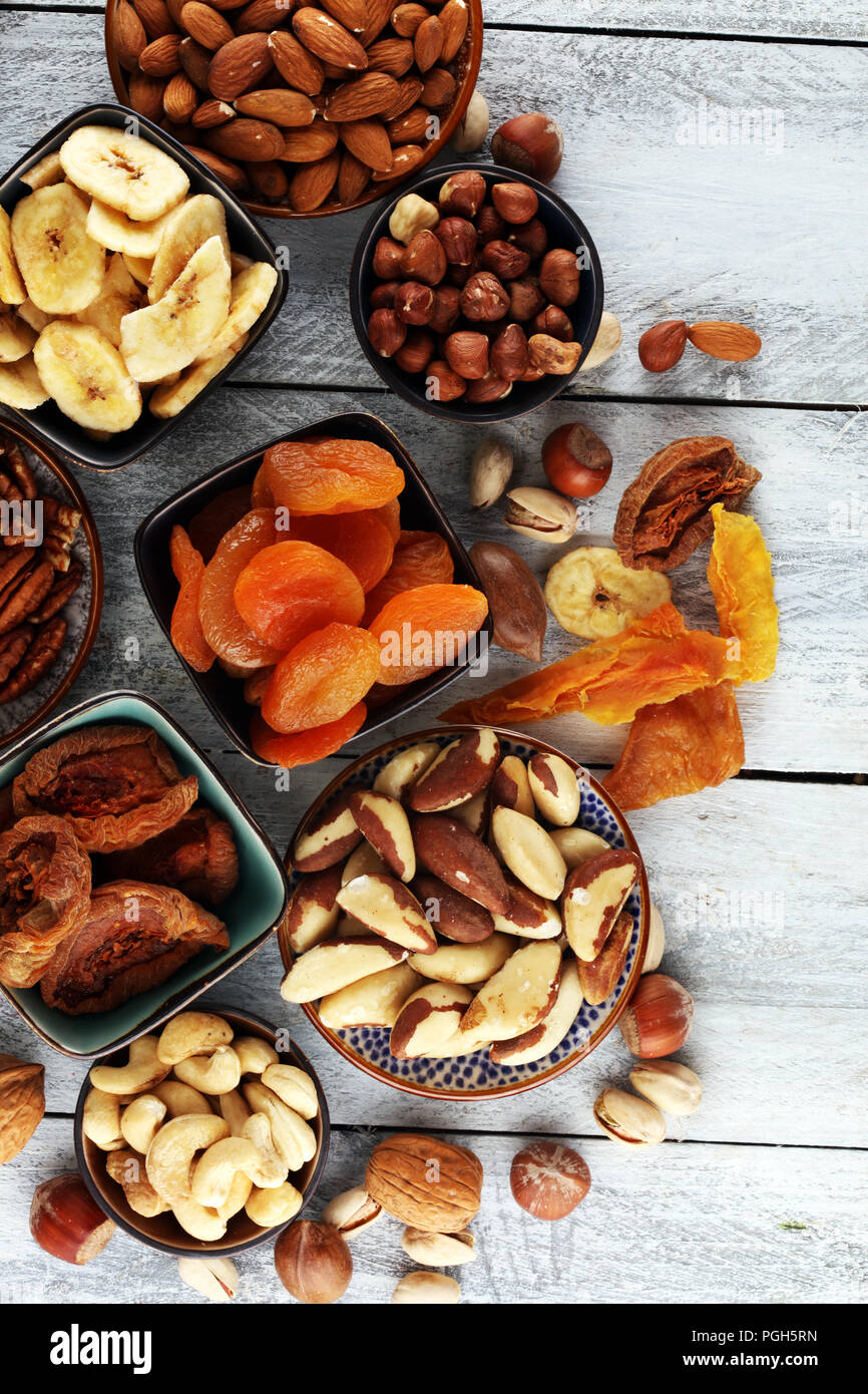 dried fruits and assorted nuts composition on rustic table Stock Photo ...