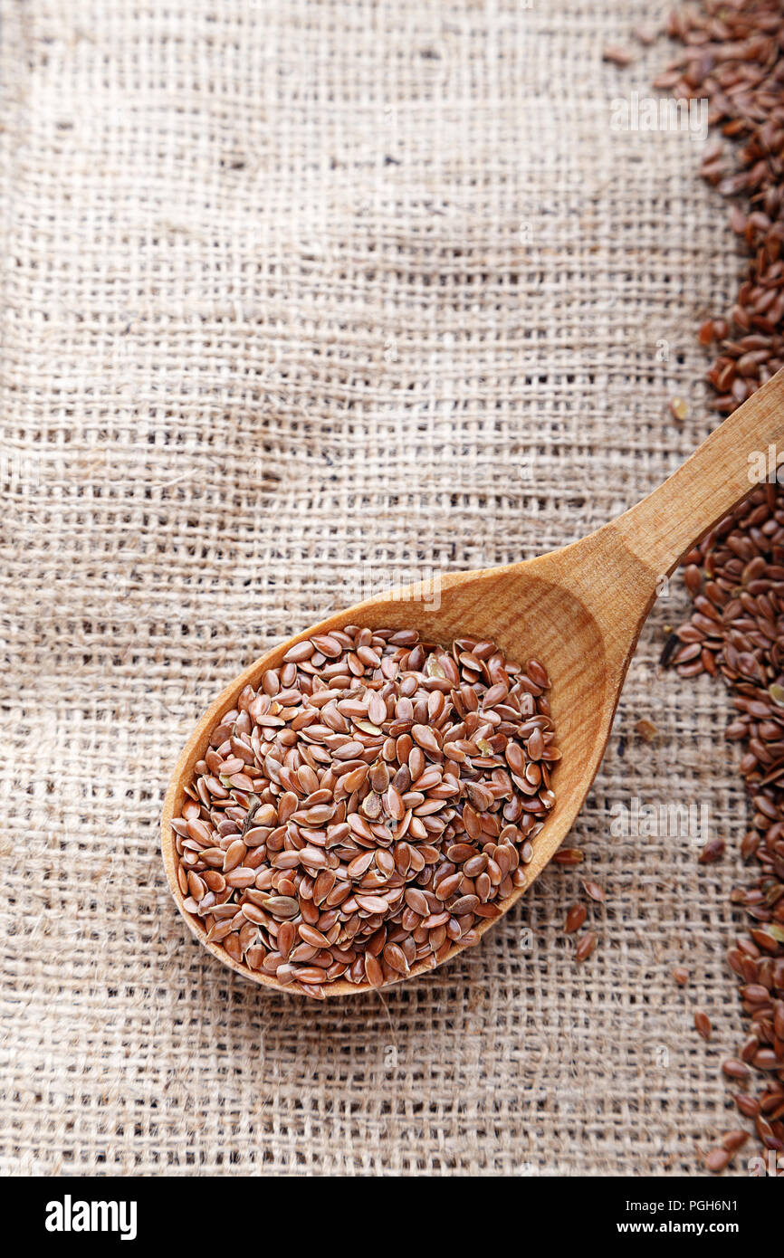 The seeds of flax are scattered on the table, on a linen napkin. Seeds ...