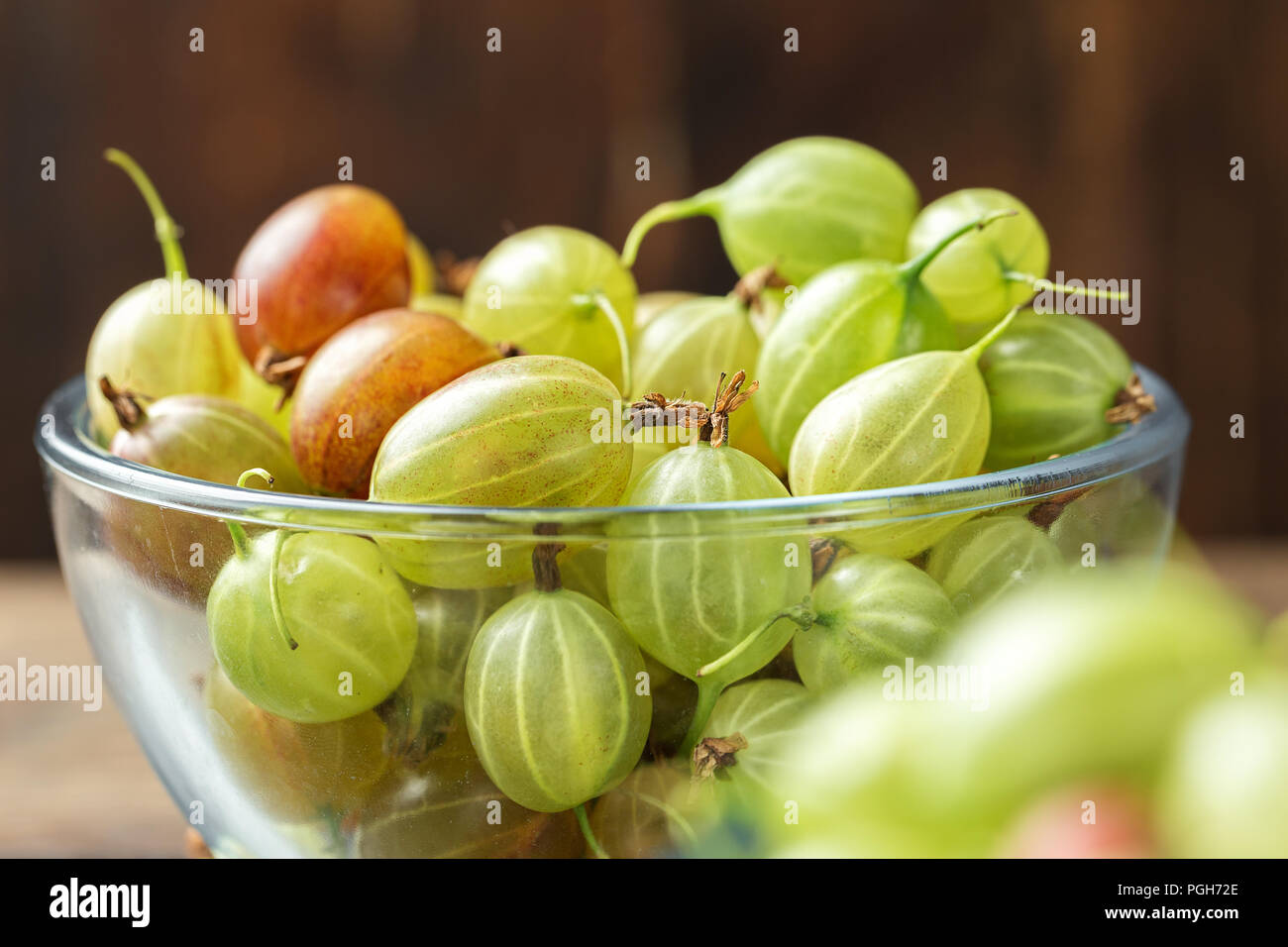 Gooseberries in a glass plate, preparation for preparation of berry ...