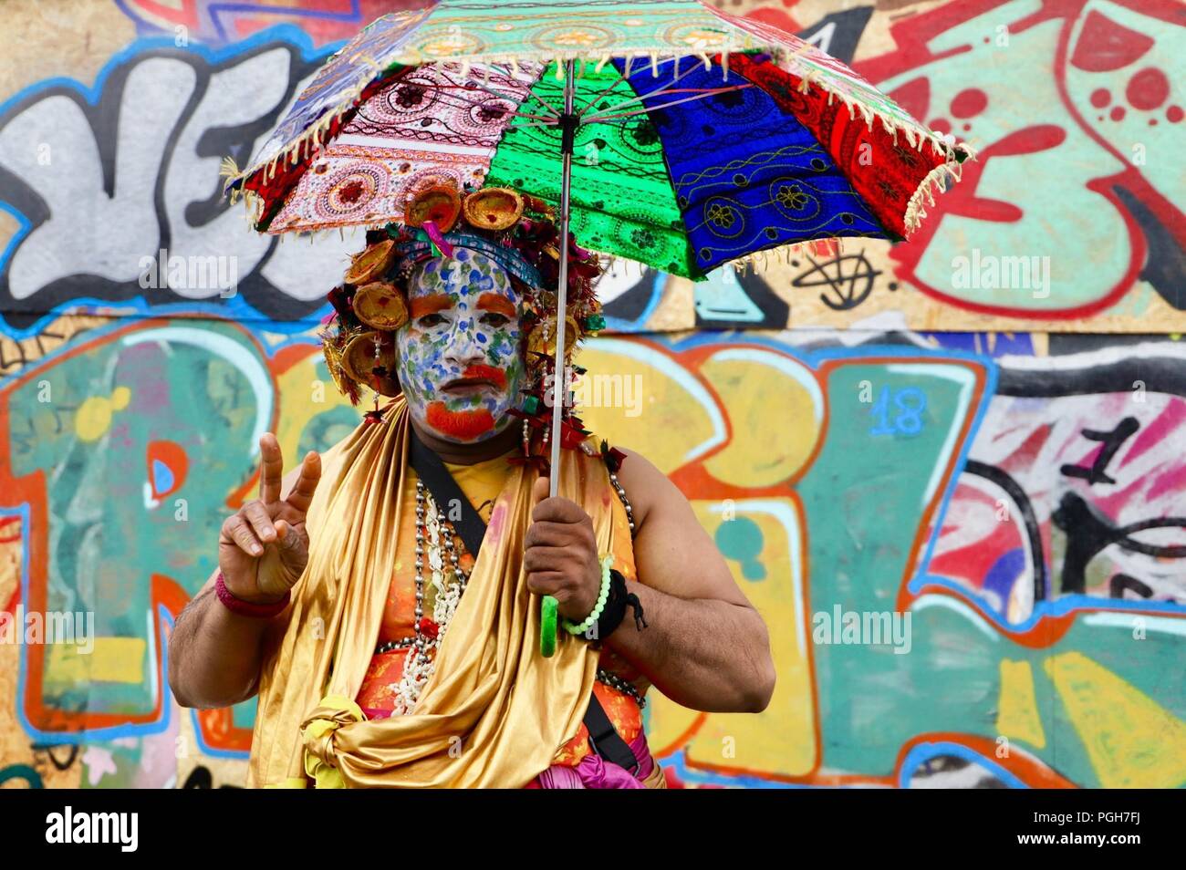 Carnival goers brave the heavy rain during the Children's Day parade at ...
