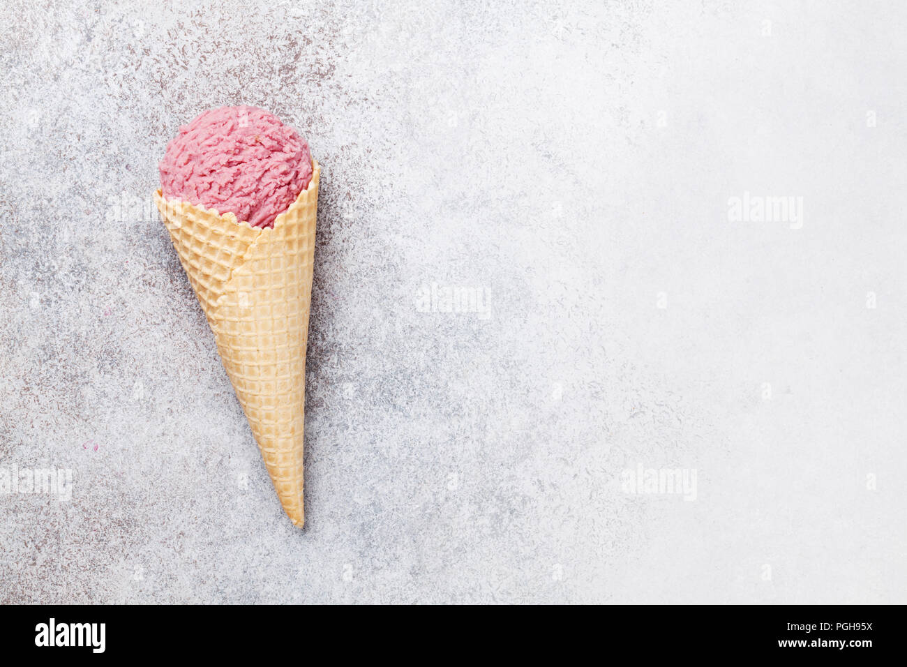 Ice cream cone with berry scoop. Top view with space for your text ...