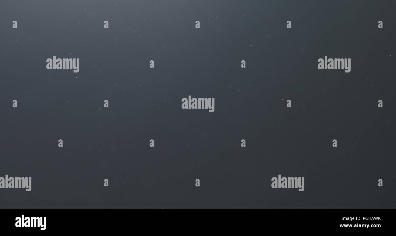 backlit dust particles floating in the air on a black background, wide ...