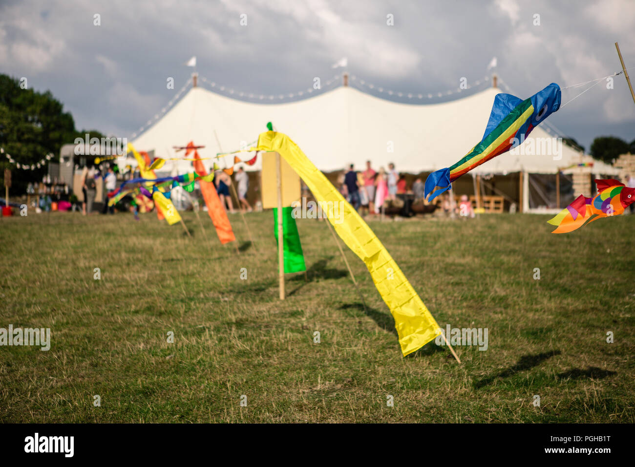 Rainbow coloured wind spinners blowing on windy day at festivals Stock ...