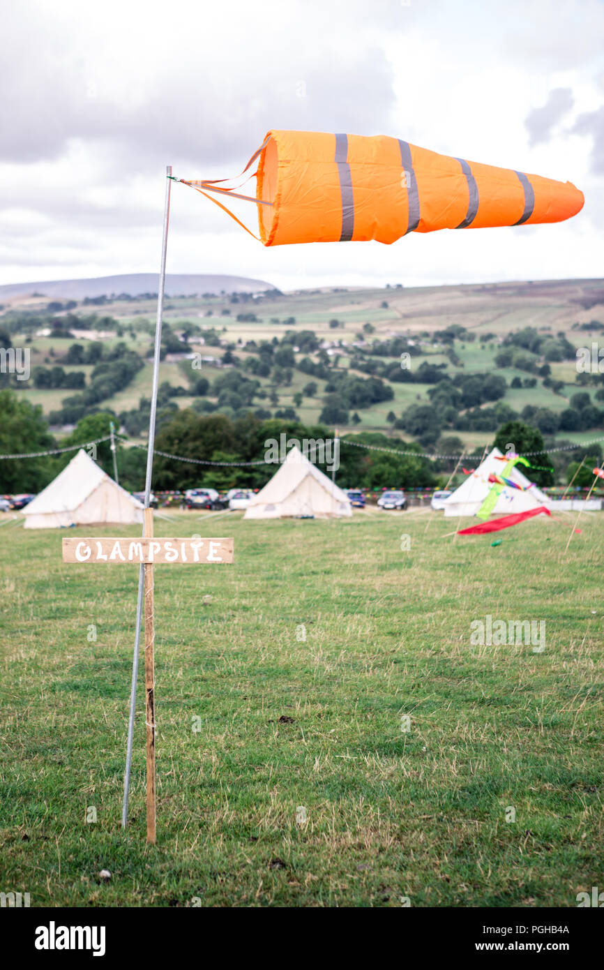 windsock blowing at full force in glampsite, hills in background ...