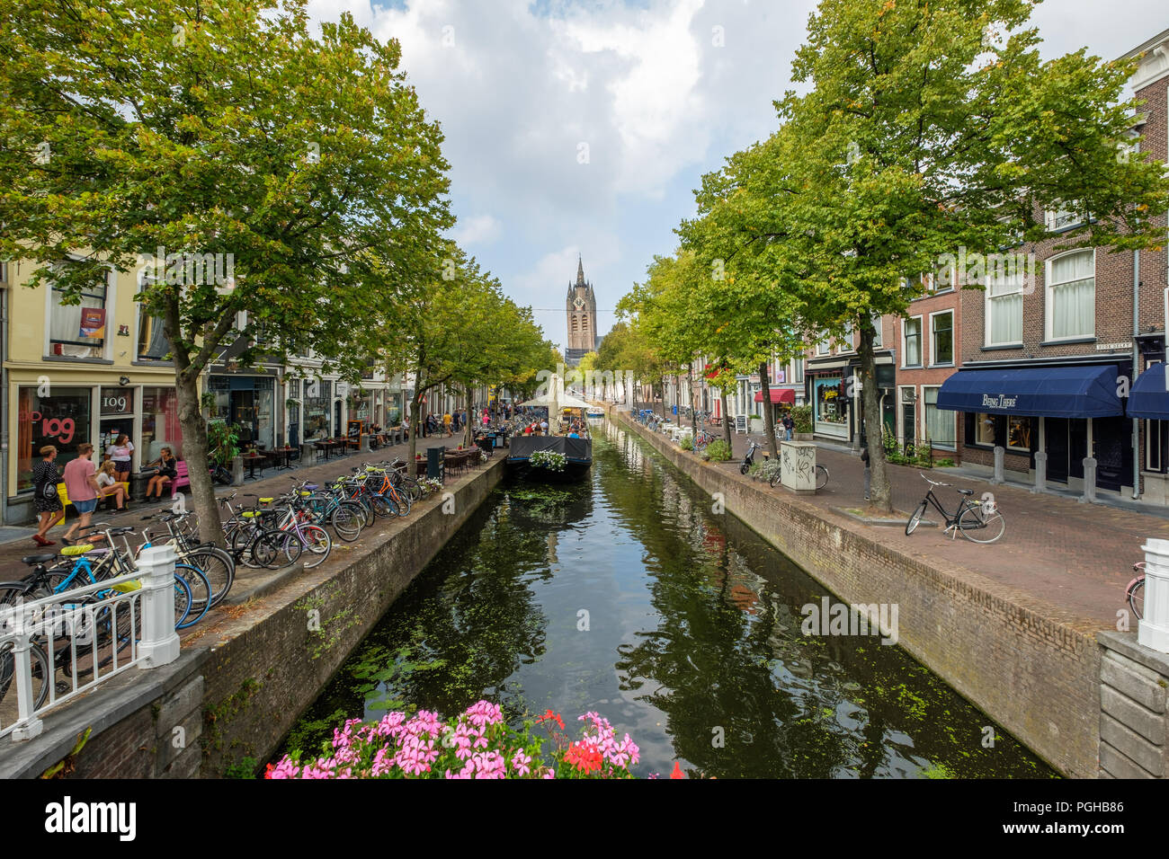 A terrace boat in a canal, and a view of the leaning tower, Delft ...