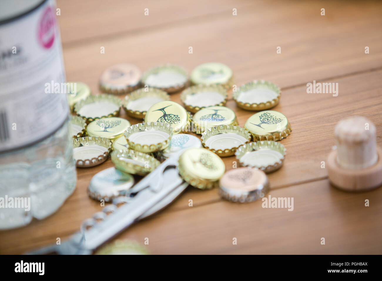 Pile of tonic water bottle caps on table Stock Photo - Alamy