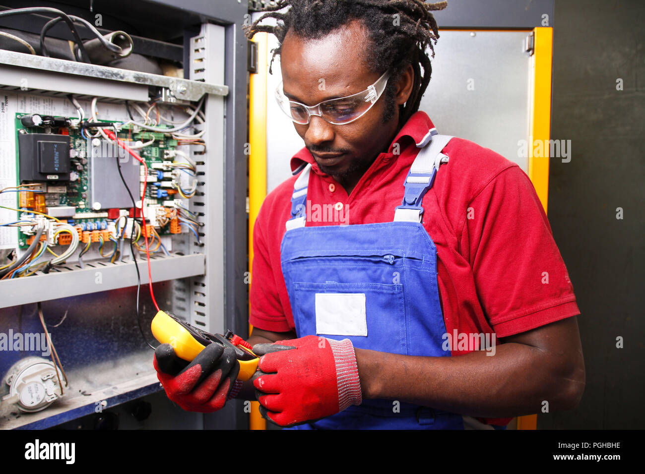 An electrician fixing a compressor engine, control panel Stock Photo ...