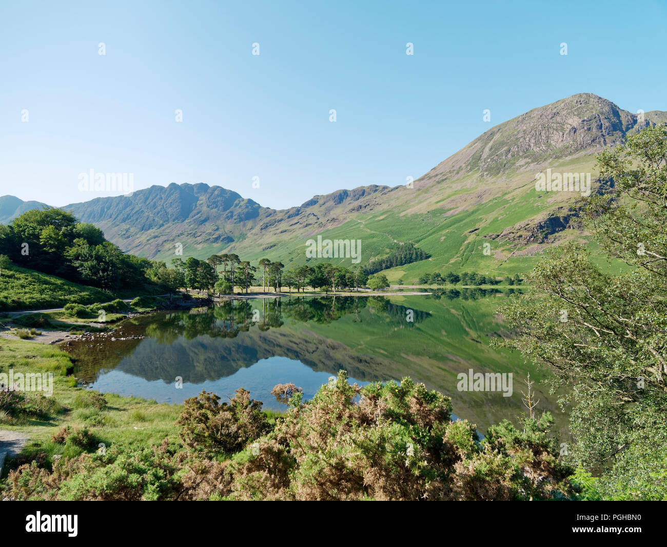 A calm day in the English Lake District shows the famous Buttermere ...