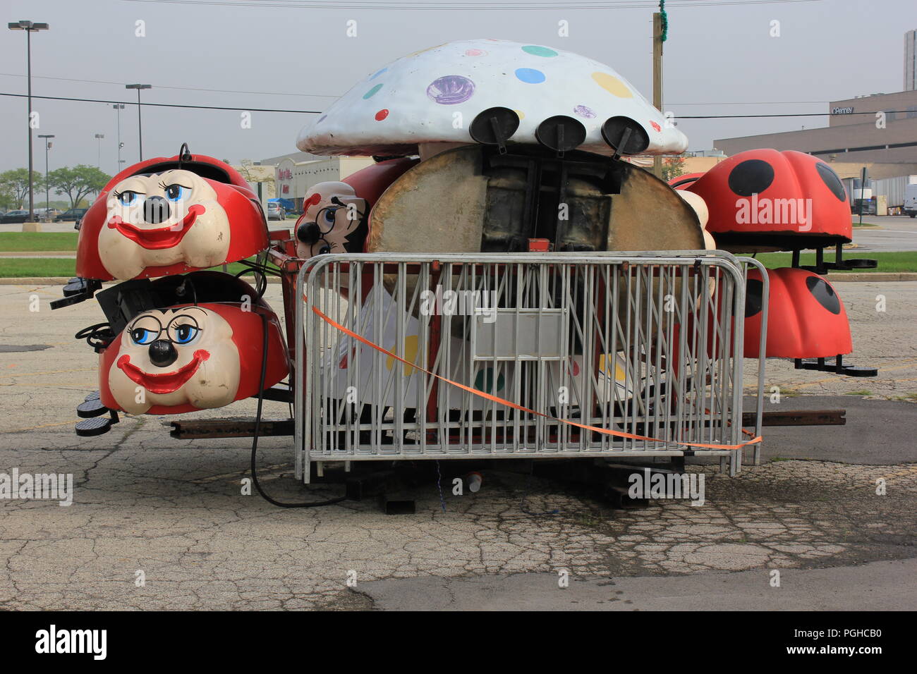 Traveling kiddie lady bug carnival ride under construction in a ...
