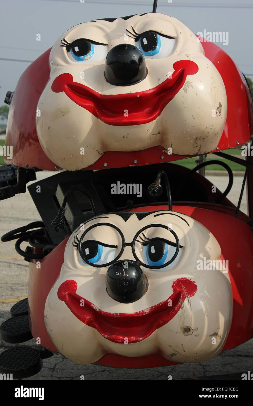 Traveling kiddie lady bug carnival ride under construction in a ...