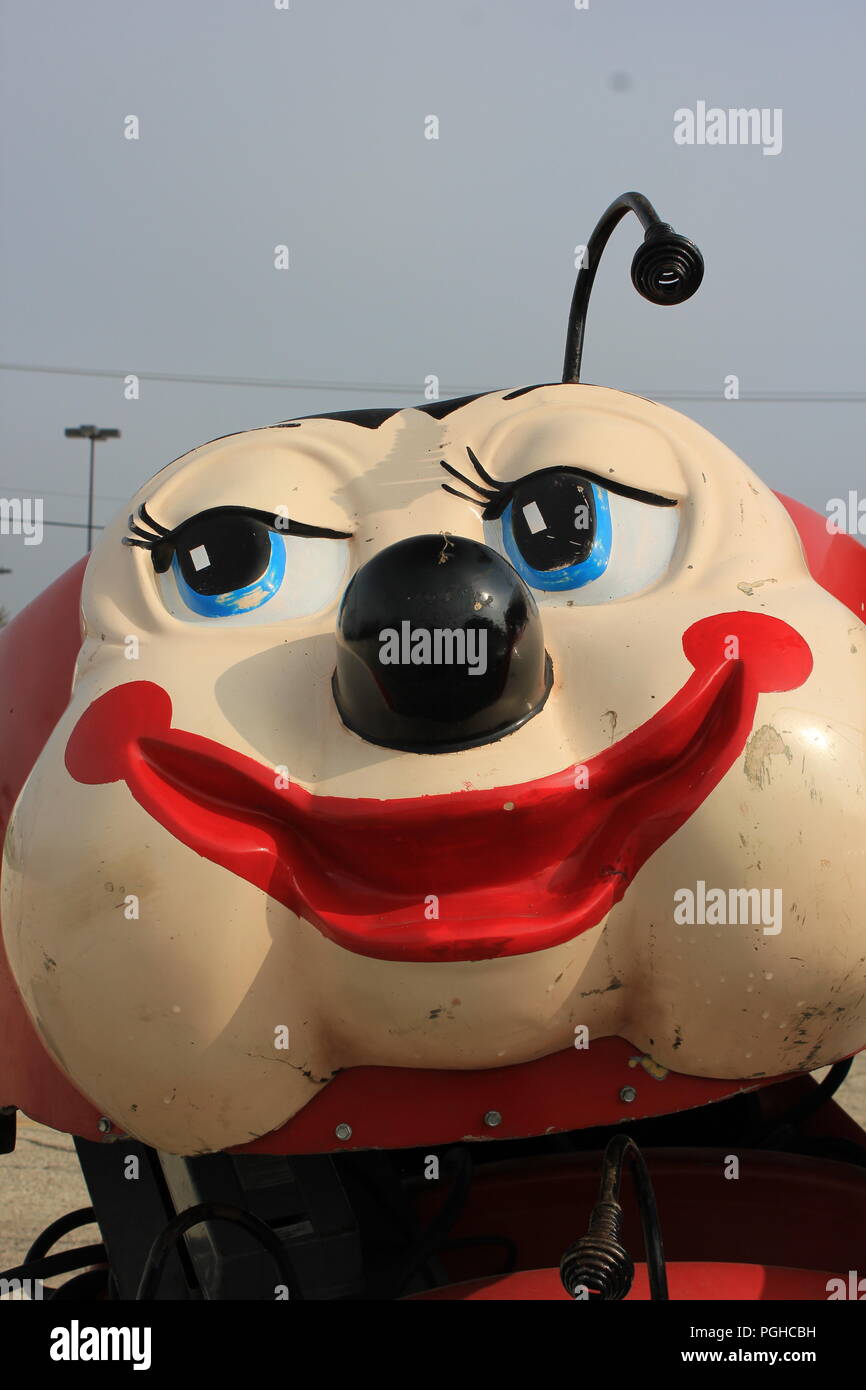 Traveling kiddie lady bug carnival ride under construction in a ...