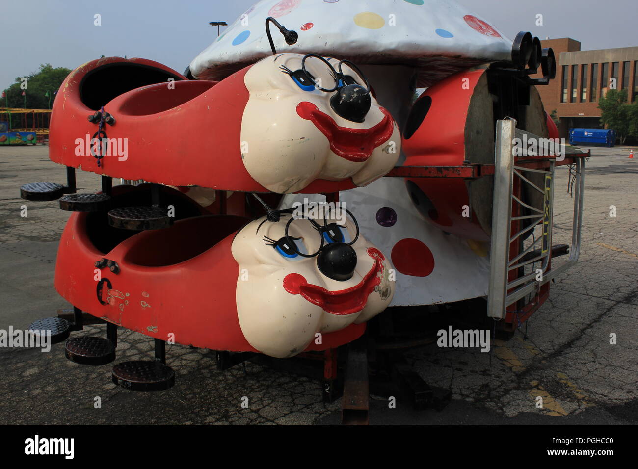 Traveling kiddie lady bug carnival ride under construction in a ...