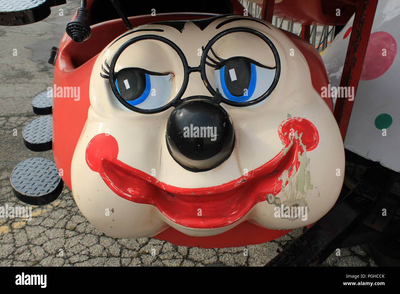 Traveling kiddie lady bug carnival ride under construction in a ...