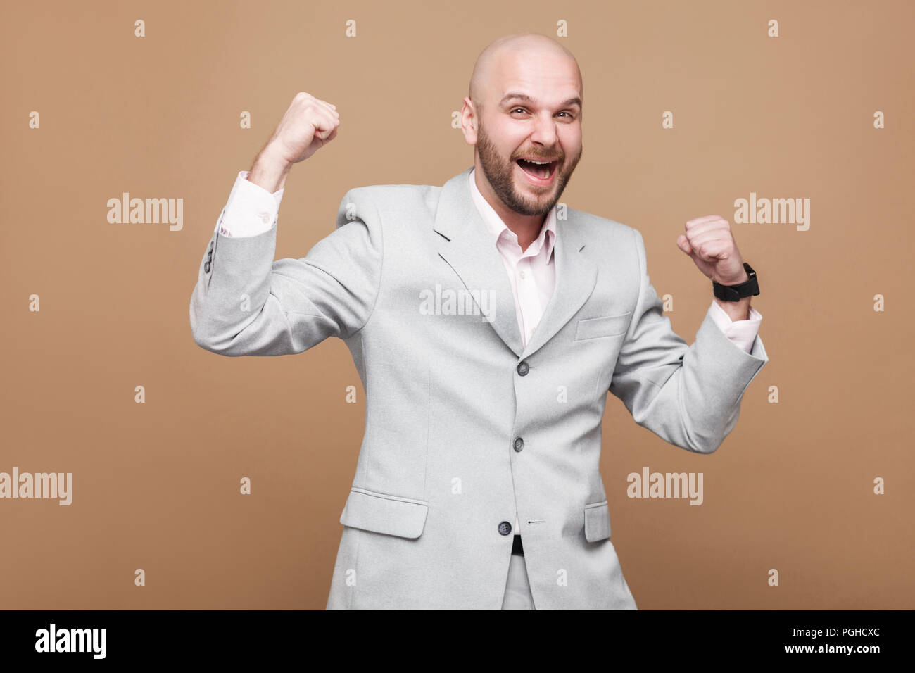Portrait Of Satisfed Happy Winner Handsome Middle Aged Bald Bearded