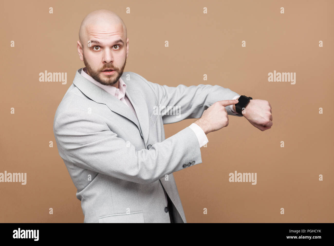 Time is gone. Serious handsome middle aged bald bearded businessman ...