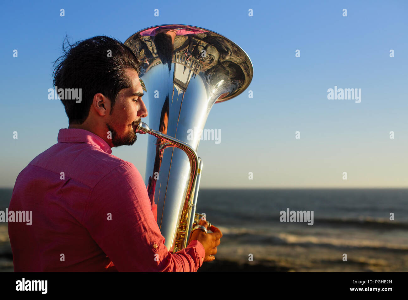 Musician playing the Tuba on the ocean coast Stock Photo - Alamy