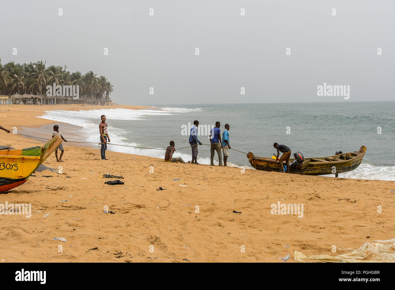 LOME, TOGO - Jan 9, 2017: Unidentified Togolese men pull a boat out of ...