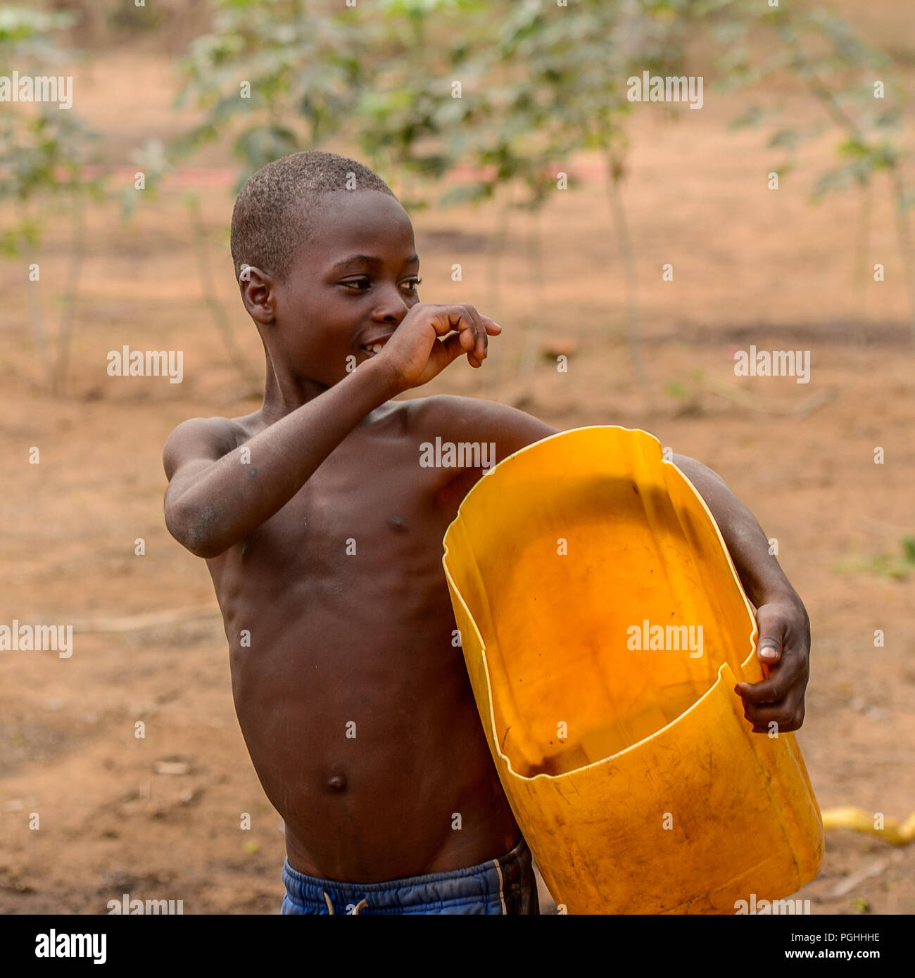 LOME, TOGO - Jan 9, 2017: Unidentified Togolese young boy holds yellow ...