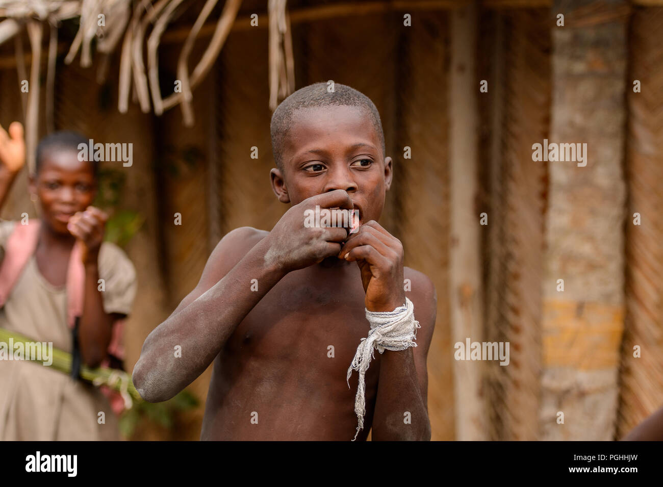 LOME, TOGO - Jan 9, 2017: Unidentified Togolese young boy puts some ...