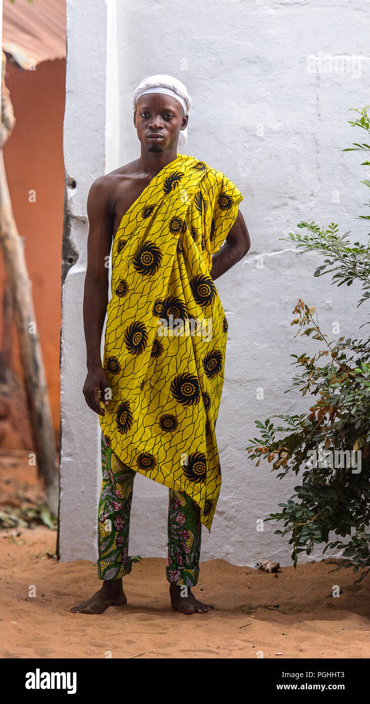OUIDAH, BENIN - Jan 9, 2017: Unidentified Beninese man in colored suit ...