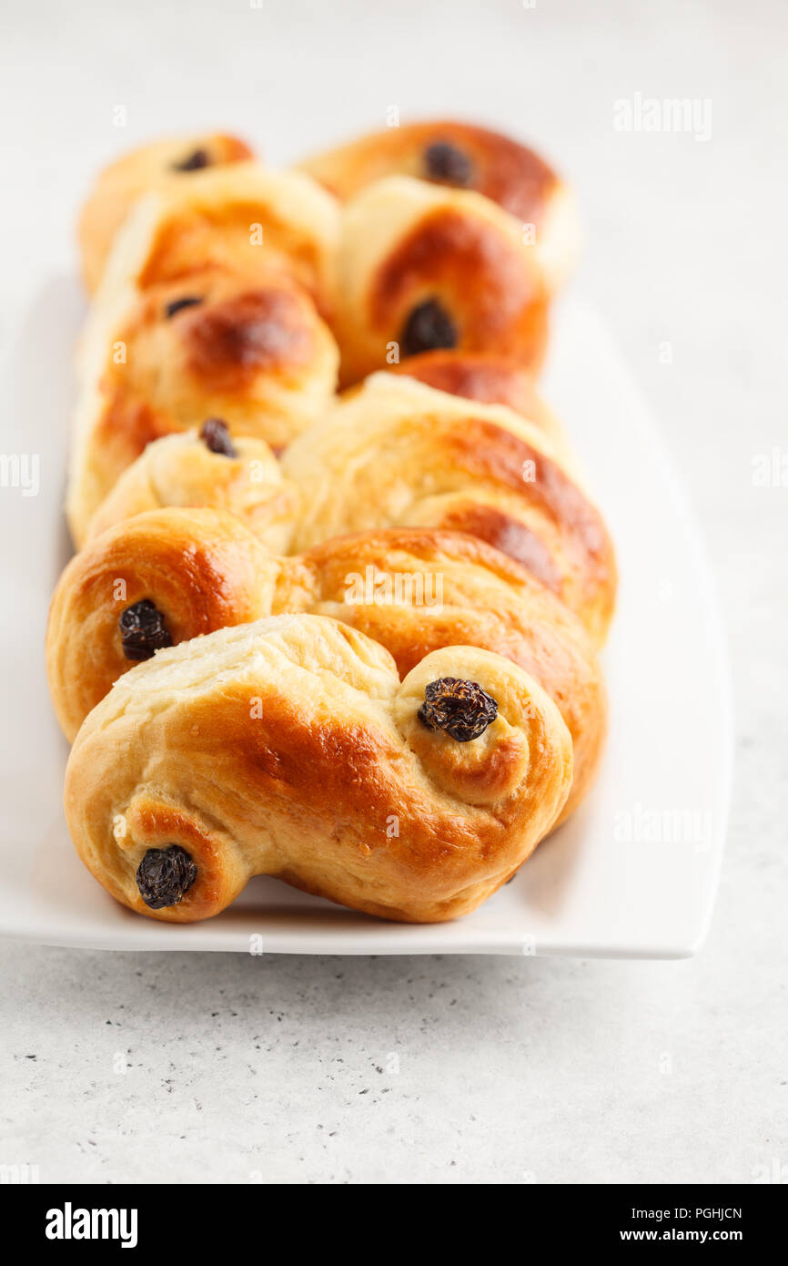 Traditional Swedish saffron buns (lussebulle or lussekatt), white ...