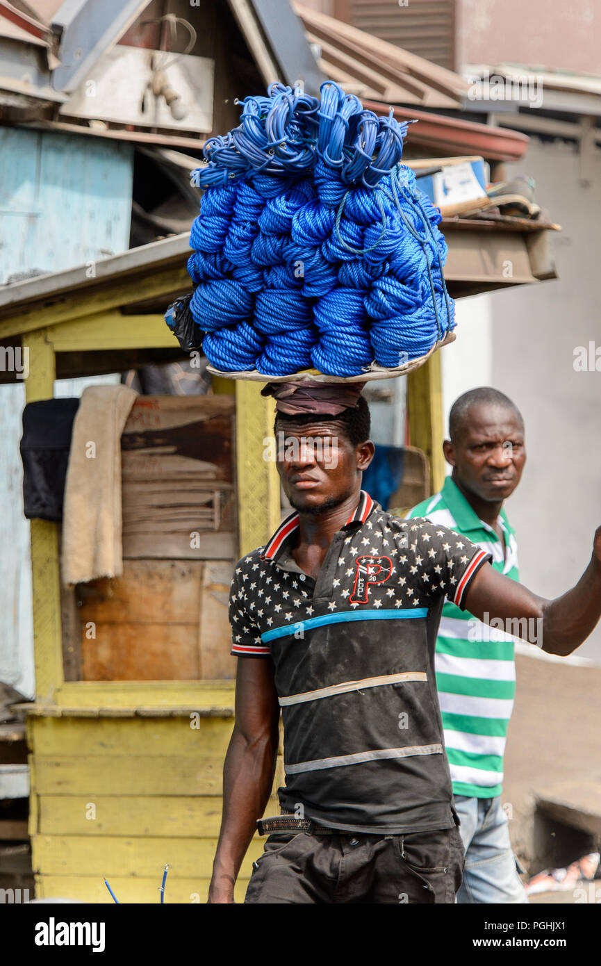 ACCRA, GHANA - Jan 8, 2017: Unidentified Ghanaian man carries a tray ...