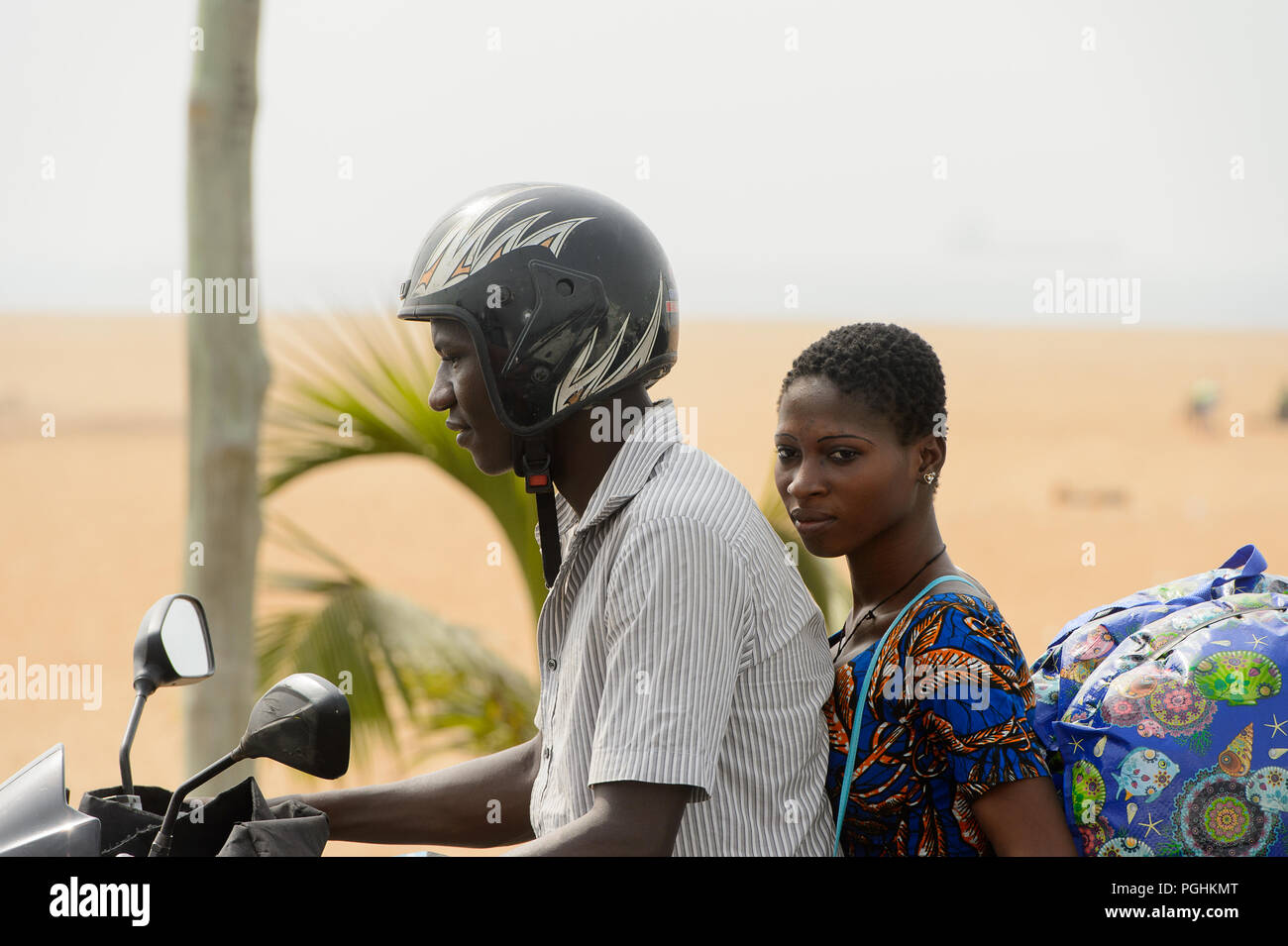 LOME, TOGO - Jan 9, 2017: Unidentified Togolese man in helmet rides a ...