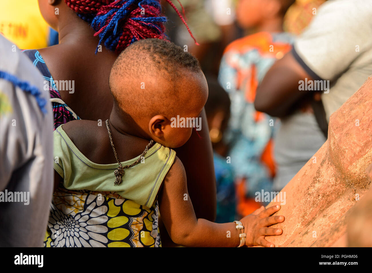 OUIDAH, BENIN - Jan 10, 2017: Unidentified Beninese little baby carried ...