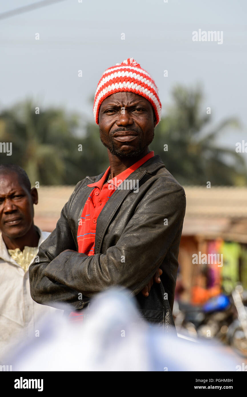 OUIDAH, BENIN - Jan 10, 2017: Unidentified Beninese man in red shirt ...