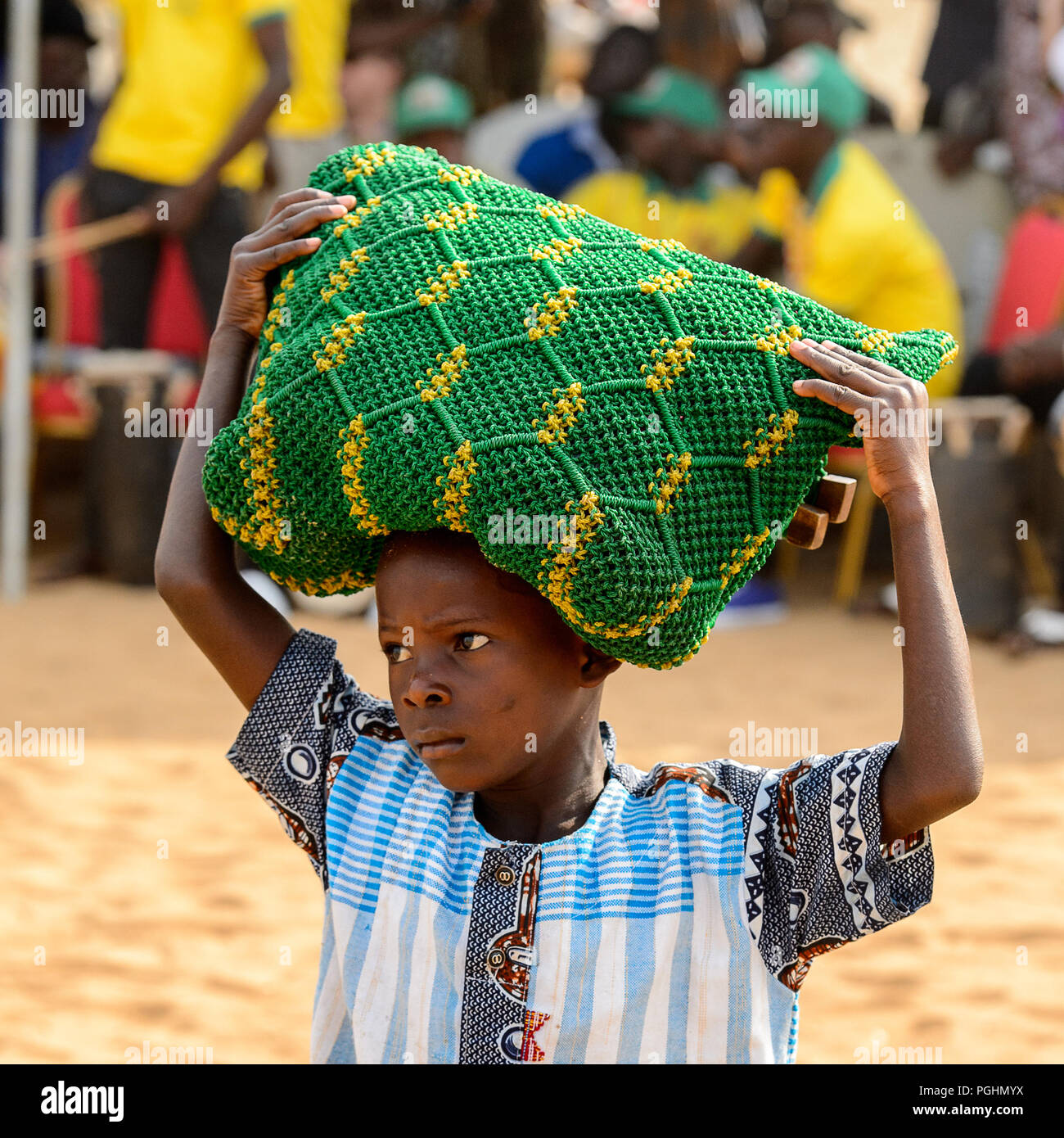 OUIDAH, BENIN - Jan 10, 2017: Unidentified Beninese little boy carries ...