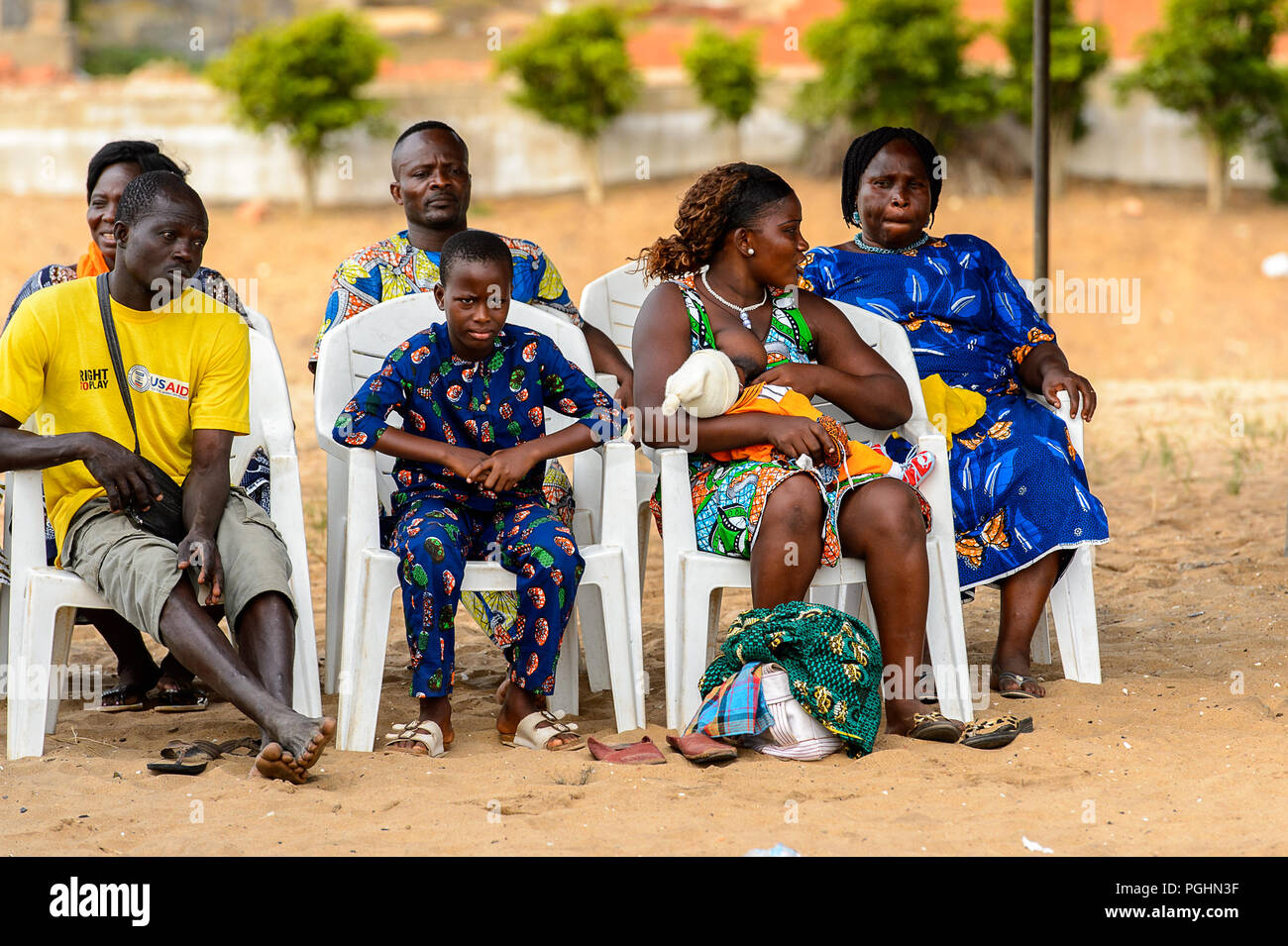 OUIDAH, BENIN - Jan 10, 2017: Unidentified Beninese group of people sit ...